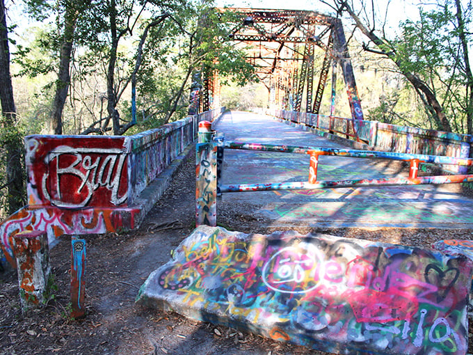 This old truss bridge has transformed from transportation infrastructure to cultural landmark, where rust and art create an unlikely partnership.