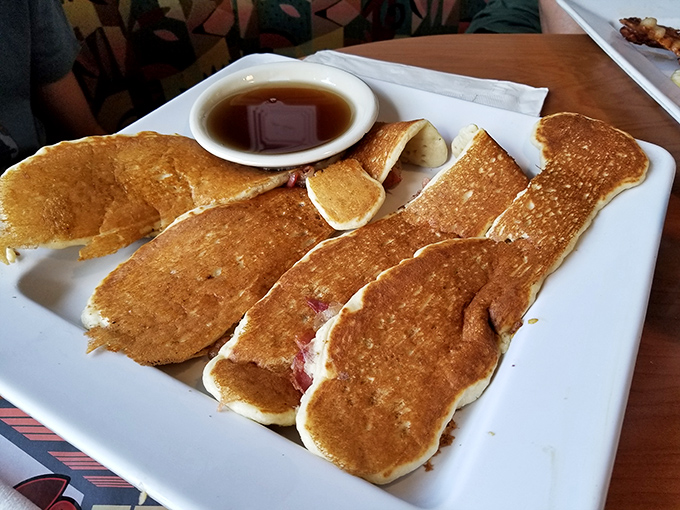 Pancakes so perfectly golden they deserve their own Academy Award. The syrup puddle waiting to happen is just nature's way of saying "good morning."
