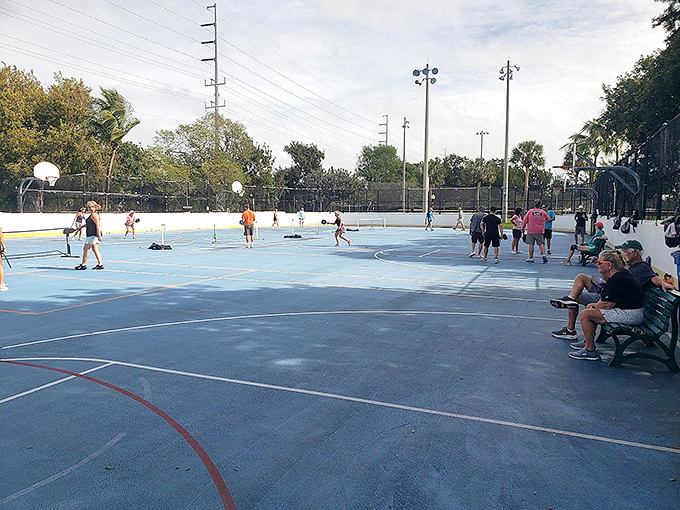 People Playing and Seated Community in motion &ndash; players dash across the court while spectators provide running commentary from their front-row bench seats.
