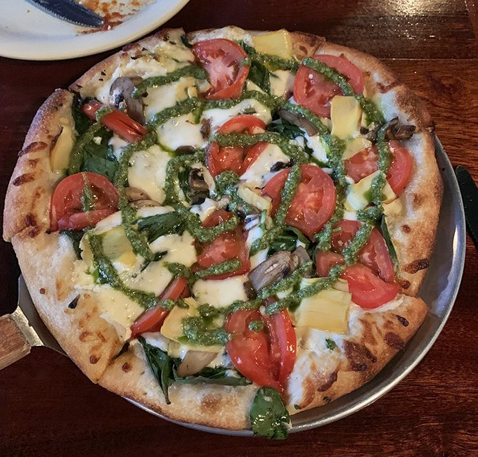 Garden-fresh ingredients dance atop vibrant pesto &ndash; a Mediterranean vacation without the passport or uncomfortable middle seat.