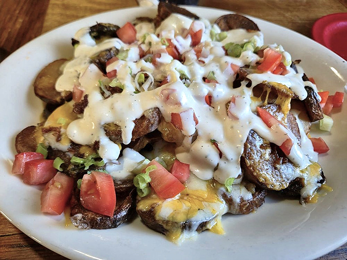 Loaded potato nachos defy physics with their perfect balance of crispy potatoes, melted cheese, and fresh toppings – a structural engineering marvel.