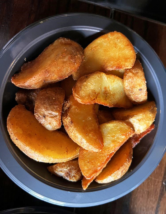 These aren't just potato wedges; they're little golden nuggets of comfort, crispy-edged and fluffy-centered, seasoned to perfection.