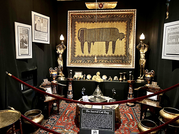 Ancient Egyptian artistry meets modern museum curation in this dramatic display of the Sacred Cat Rug, complete with ceremonial guardians.