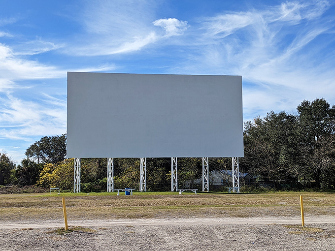 The massive white screen stands ready against Florida's blue sky, waiting for dusk to transform into a portal to other worlds.