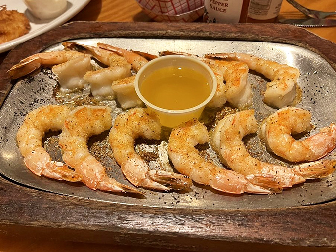 Perfectly cooked shrimp glisten on the plate, their pink curves promising sweet, tender bites that need nothing more than a quick butter bath.