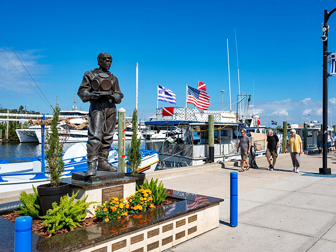 Where American and Greek flags fly side by side, boats bob gently as visitors stroll past the iconic sponge diver statue.