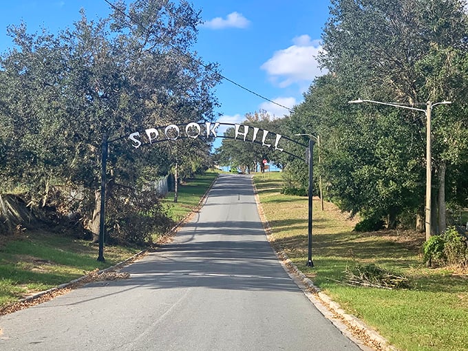Blue skies frame the famous archway, inviting curious travelers to test gravity's limits on this peculiar stretch of Florida road.