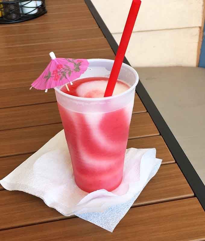A frozen strawberry wine drink that's basically a vacation in a cup with a straw.