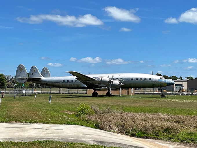 The iconic Lockheed Constellation with its distinctive triple-tail design sits majestically outside &ndash; once the pinnacle of luxury air travel before jets took over.