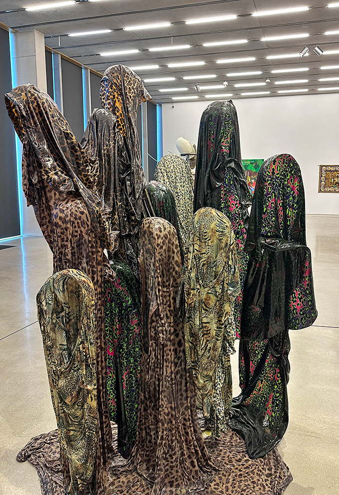 Kevin Beasley's "Untitled (Parade)" stands draped in patterned fabrics, a silent gathering of forms that whisper stories of identity and community.
