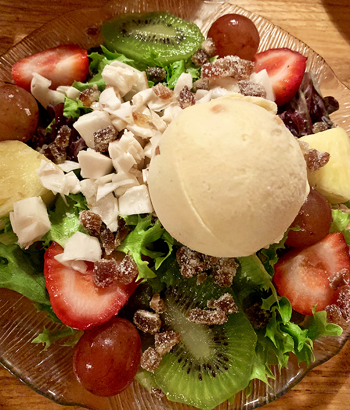 A perfect scoop of homemade ice cream crowns this fruit-laden salad &ndash; the unexpected element that transforms a simple dish into a legend.