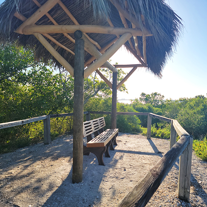 This shaded bench beneath a thatched roof offers the perfect spot to catch your breath and contemplate life's big questions—or just lunch plans.