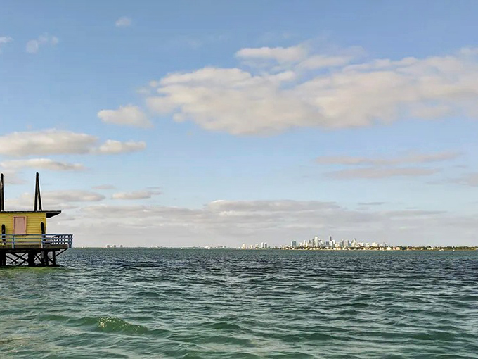 Clouds build dramatic formations above the tranquil waters, framing Stiltsville's structures in nature's perfect composition.