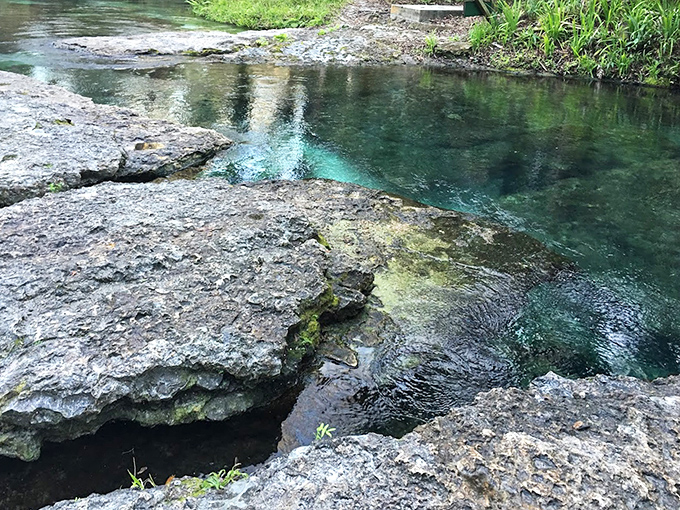 Ancient limestone formations create natural platforms perfect for contemplating life or planning your next splash.