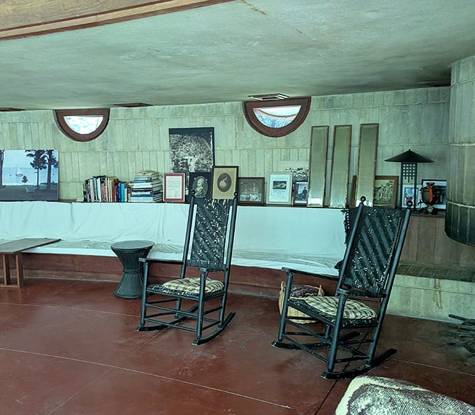 Rocking chairs await phantom conversations in this living area where Wright's vision of family gatherings and quiet contemplation still lingers.