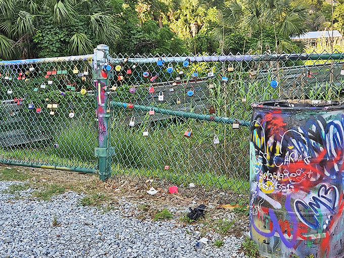 Love locks cling to fences, adding metallic glints to the rainbow of paint covering every nearby surface.