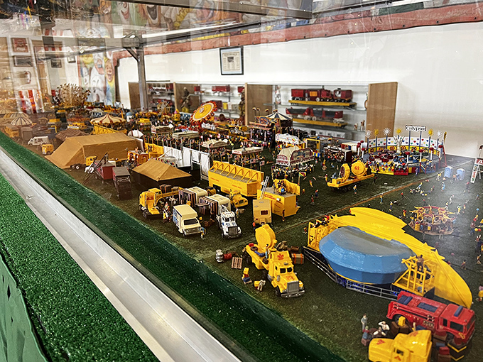 This miniature carnival diorama captures every detail of a traveling show, from tiny popcorn stands to diminutive thrill-seekers enjoying the rides.