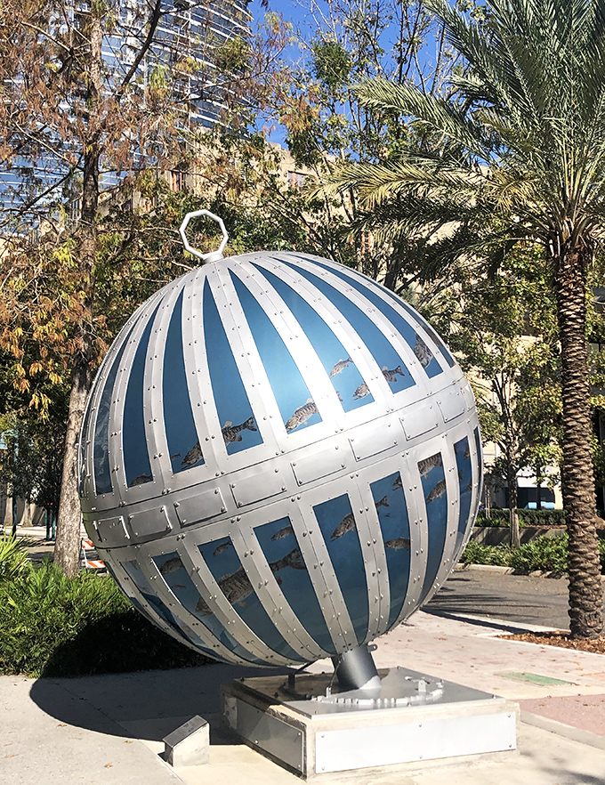 Bathed in sunshine, the sculpture's blue panels seem to ripple like actual water, creating a refreshing visual oasis amid downtown's concrete landscape.