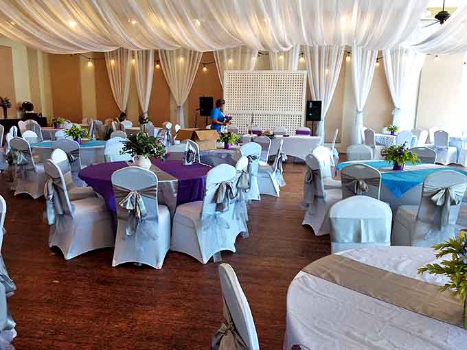 Elegant white draping transforms the ballroom for wedding receptions, where couples begin their stories in a building filled with countless others.