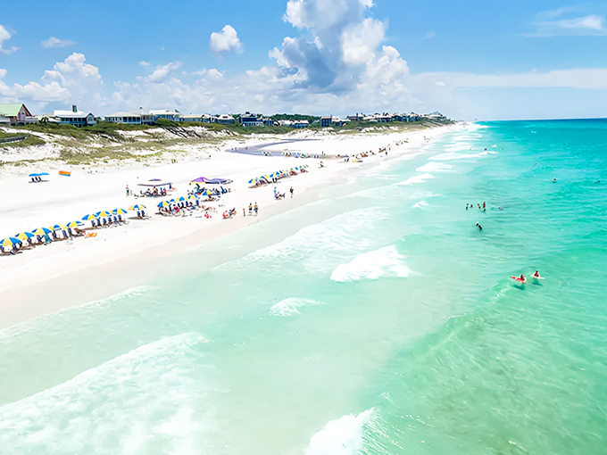 The pristine shoreline of Blue Mountain Beach stretches into the distance, where beachgoers enjoy the famous squeaky-clean white sand.
