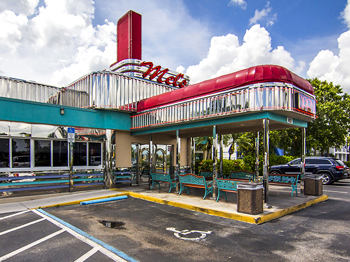 Mel's Diner's striking turquoise and chrome exterior with its towering red sign stands as a beacon of hope for the hungry traveler in Fort Myers.
