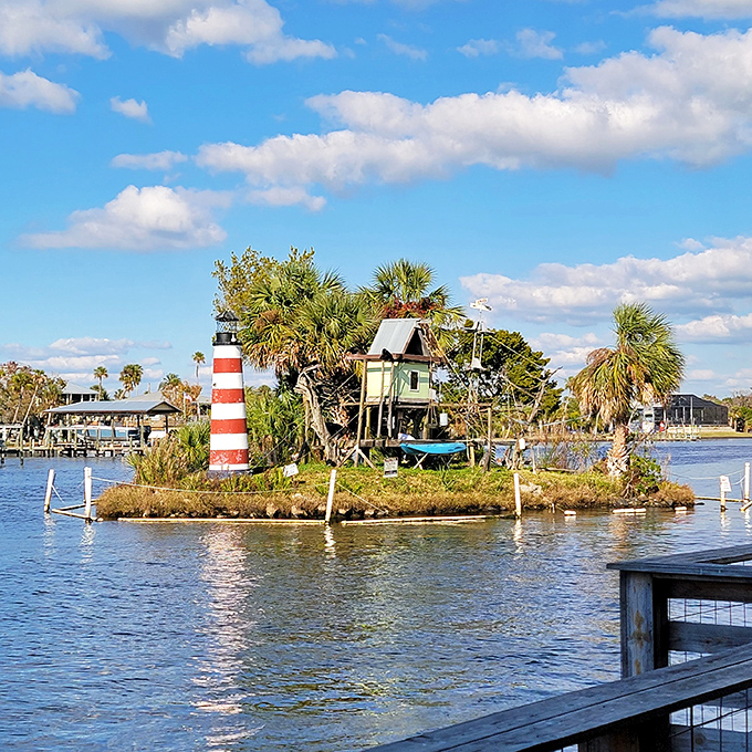 Monkey business! This island resident seems to be enjoying his private paradise, complete with palm trees and a quirky lighthouse.
