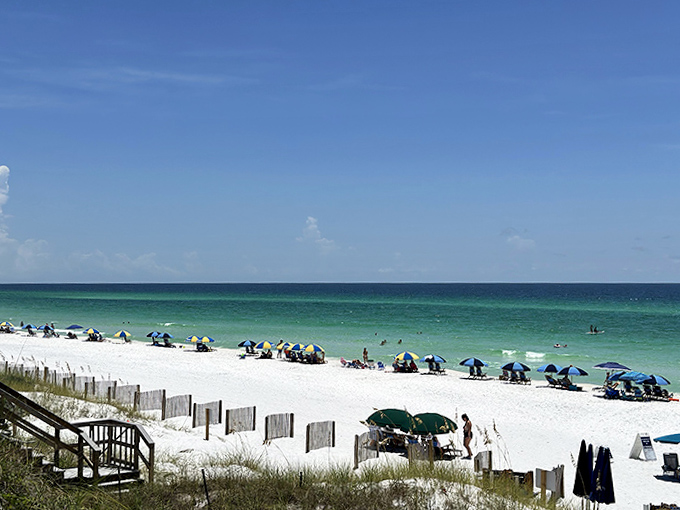 Blue Mountain Beach's famous emerald waters create a stunning contrast against the sugar-white sand, living up to its jewel-toned reputation.