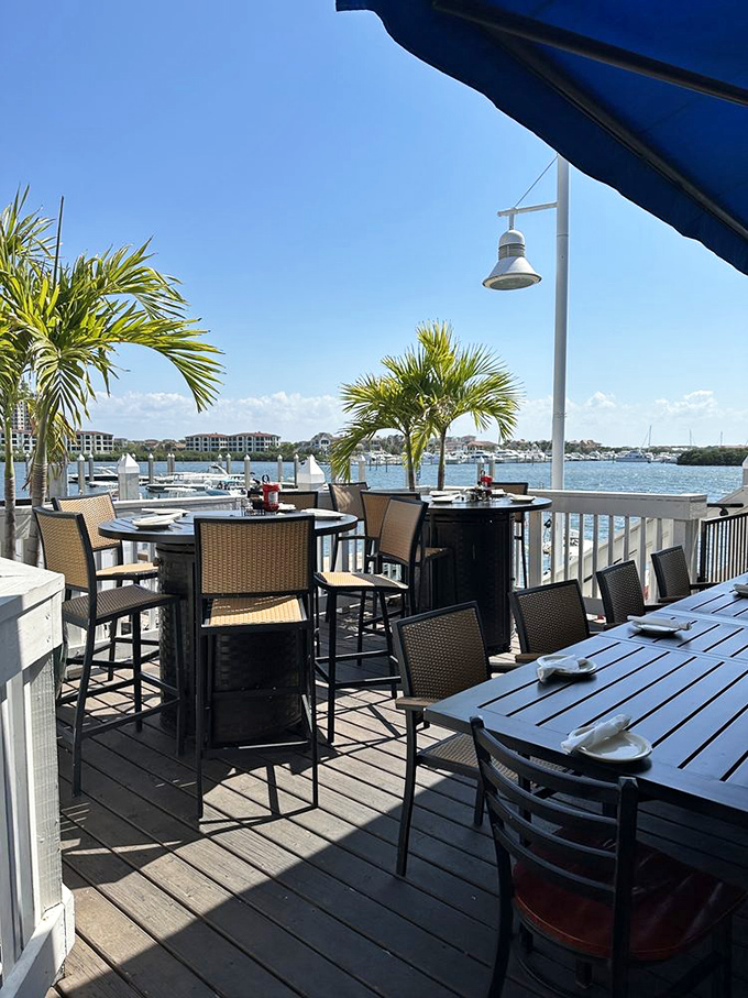 The perfect spot to watch boats drift by while enjoying fresh seafood with warm sunshine and breezy palms.