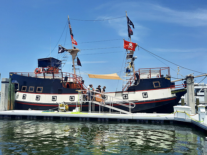 This wooden vessel stands ready at Fort Myers Beach, its flags snapping in the breeze as it awaits its next crew of adventure-seekers.