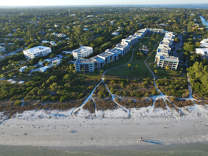 Thoughtful pathways lead beachgoers to Sanibel's famous shoreline like nature's welcome mat. The island's commitment to preservation is evident in how buildings respectfully nestle among the tropical landscape rather than dominating it.
