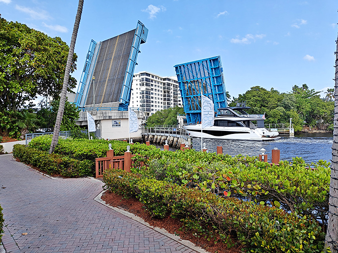 The Atlantic Avenue Bridge opens its blue arms to welcome passing boats, a mechanical ballet performed daily on Delray's Intracoastal Waterway.