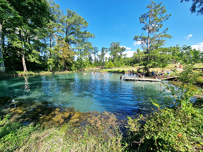 Blue Hole Spring's crystal waters invite swimmers to cool off, a refreshing reward after exploring the underground wonders.