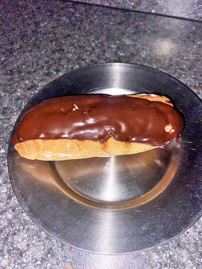 The chocolate &eacute;clair &ndash; because nothing says "authentic 11th century dining experience" quite like a perfectly executed French pastry with chocolate glaze.