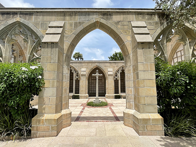 Graceful arches frame a contemplative courtyard where faith and nature intertwine, creating a pocket of peace amid Palm Beach's bustling paradise.