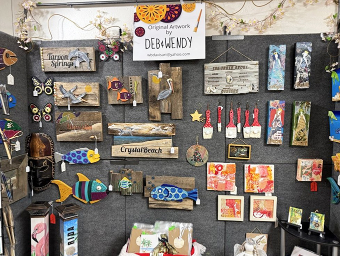 Local artistry shines in this display by Deb and Wendy, where coastal-inspired creations transform driftwood and found objects into whimsical wall art.