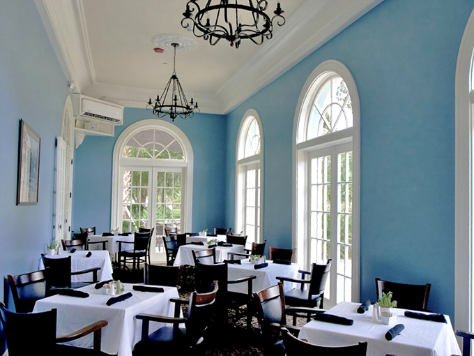 Dining Room Interior: Bathed in natural light, the dining room's blue walls and soaring windows create the perfect backdrop for meals that linger pleasantly into the afternoon.