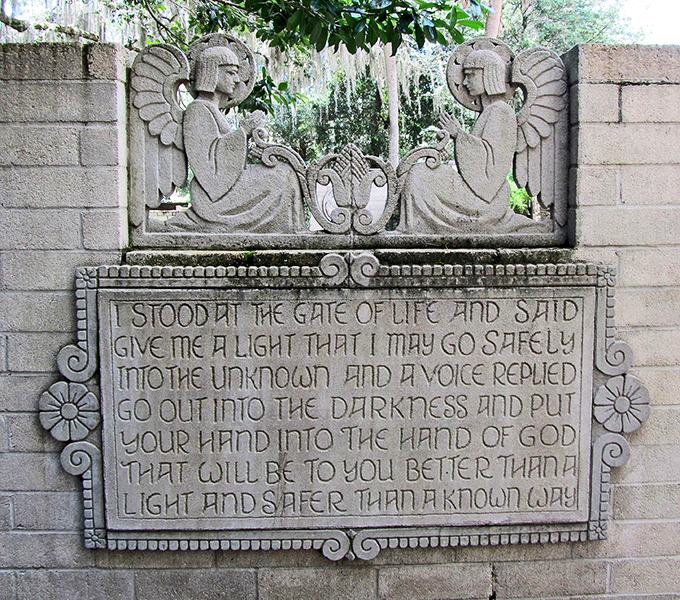 Angels watch eternally from this stone relief, their weathered faces bearing witness to a poetic inscription that stops visitors in their tracks.
