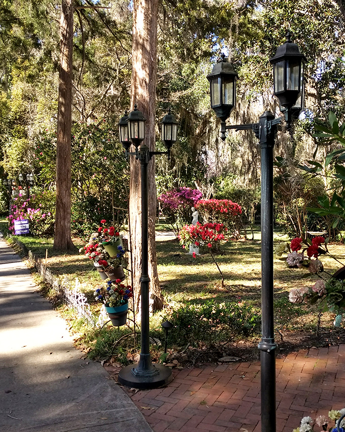 Vintage lampposts line garden pathways, creating pools of golden light as dusk settles&mdash;or perhaps illuminating the way for spectral evening strolls.