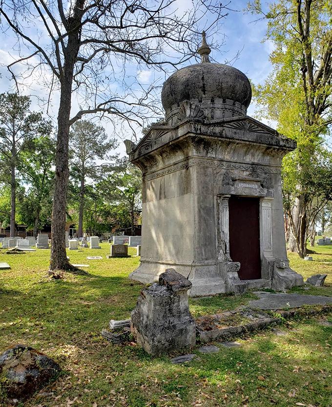 Neighboring graves keep the mausoleum company through the decades, a community of memories standing sentinel in stone and marble.
