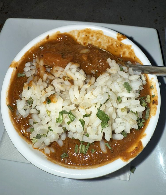 Steam rises from this hearty gumbo, where each spoonful tells the story of Louisiana's diverse culinary heritage in rich, roux-based glory.