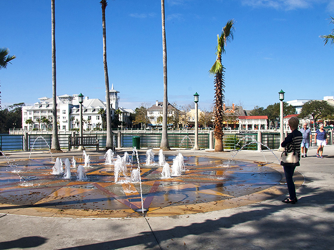 Children dash through Celebration's interactive fountain, discovering the universal truth that unexpected water jets are hilarious at any age.