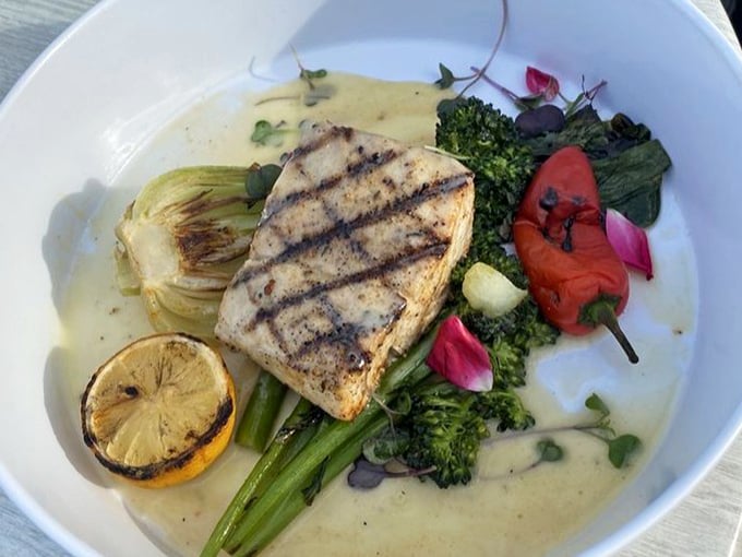 This grilled mahi-mahi doesn't just sit on the plate &ndash; it lounges there confidently, surrounded by vegetables that look like they were arranged by an artist.