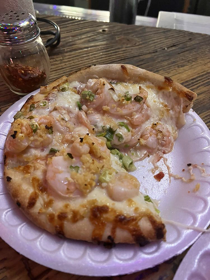 The shrimp pizza showcases what the Florida Keys does best – taking fresh seafood and transforming it into something both familiar and extraordinary.