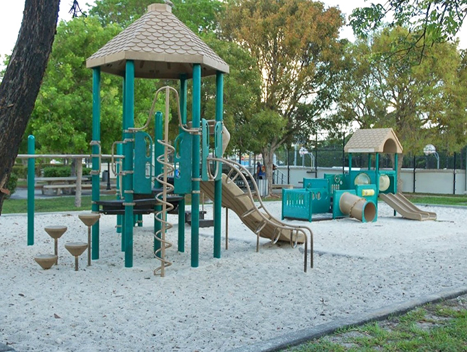 Playground A turquoise castle of childhood dreams, where slides become lava escapes and every climbing challenge conquered is worthy of parental applause.