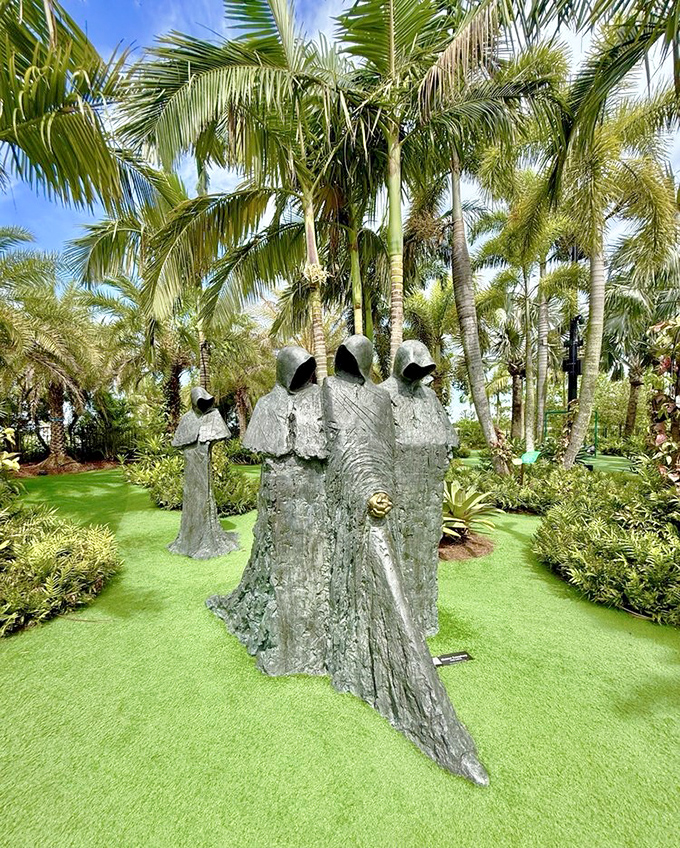 Mysterious hooded figures gather in silent communion, their metallic forms creating an otherworldly presence among the palms.