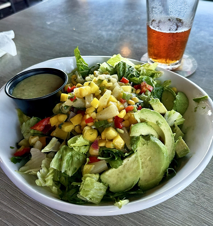 Who says healthy can't be exciting? Fresh greens, avocado, and tropical fruit create a salad that's both virtuous and vacation-worthy.