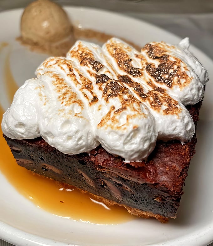 The S'mores Brownie brings campfire nostalgia to sophisticated heights, with toasted marshmallow peaks that would make the Boy Scouts jealous.