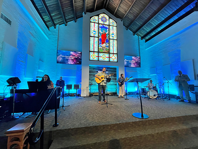 Contemporary worship brings the space to life, with musicians creating an atmosphere of joy and reverence beneath wooden beams.