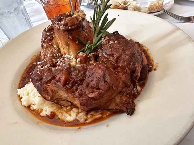 Osso buco so tender it falls off the bone, sitting pretty on creamy risotto like edible art.