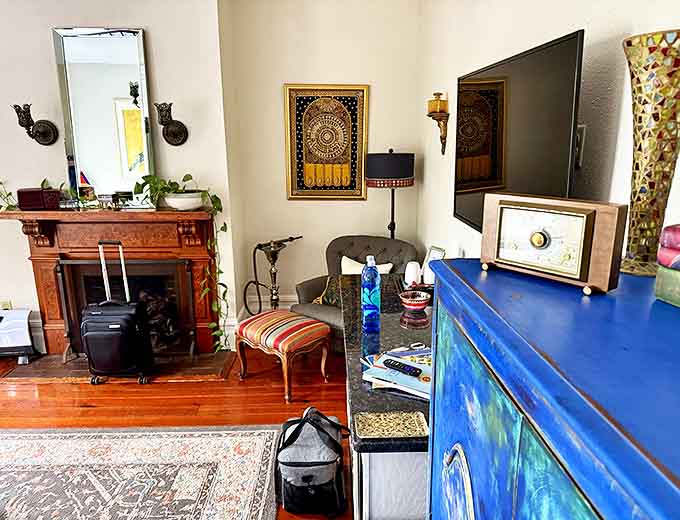 Vintage treasures and modern amenities coexist beautifully in guest rooms, where antique fireplaces stand ready to warm both the living and perhaps... others.